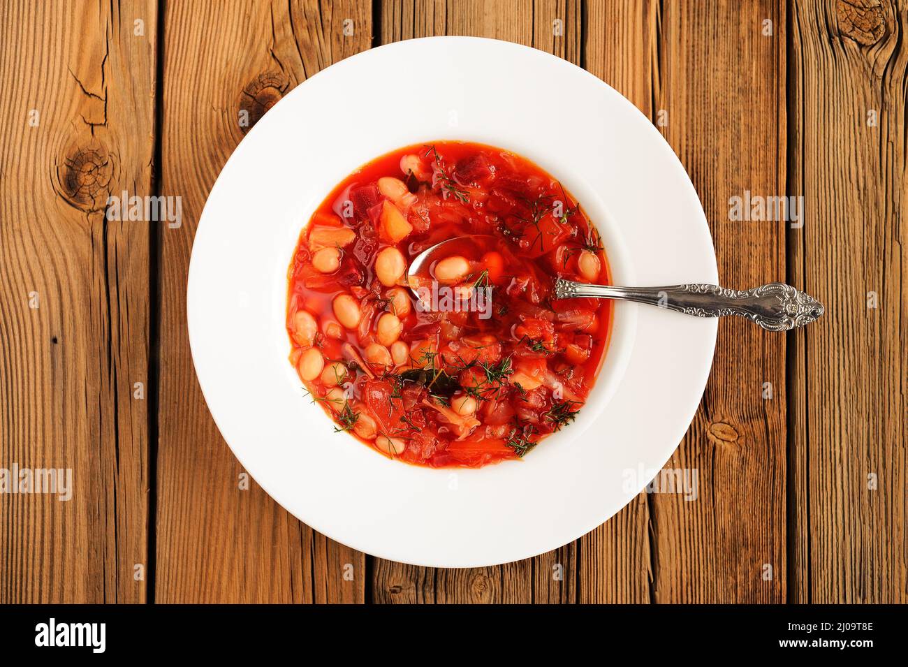 Portion of homemade Russian red beet soup borsch with bean, cabbage ...