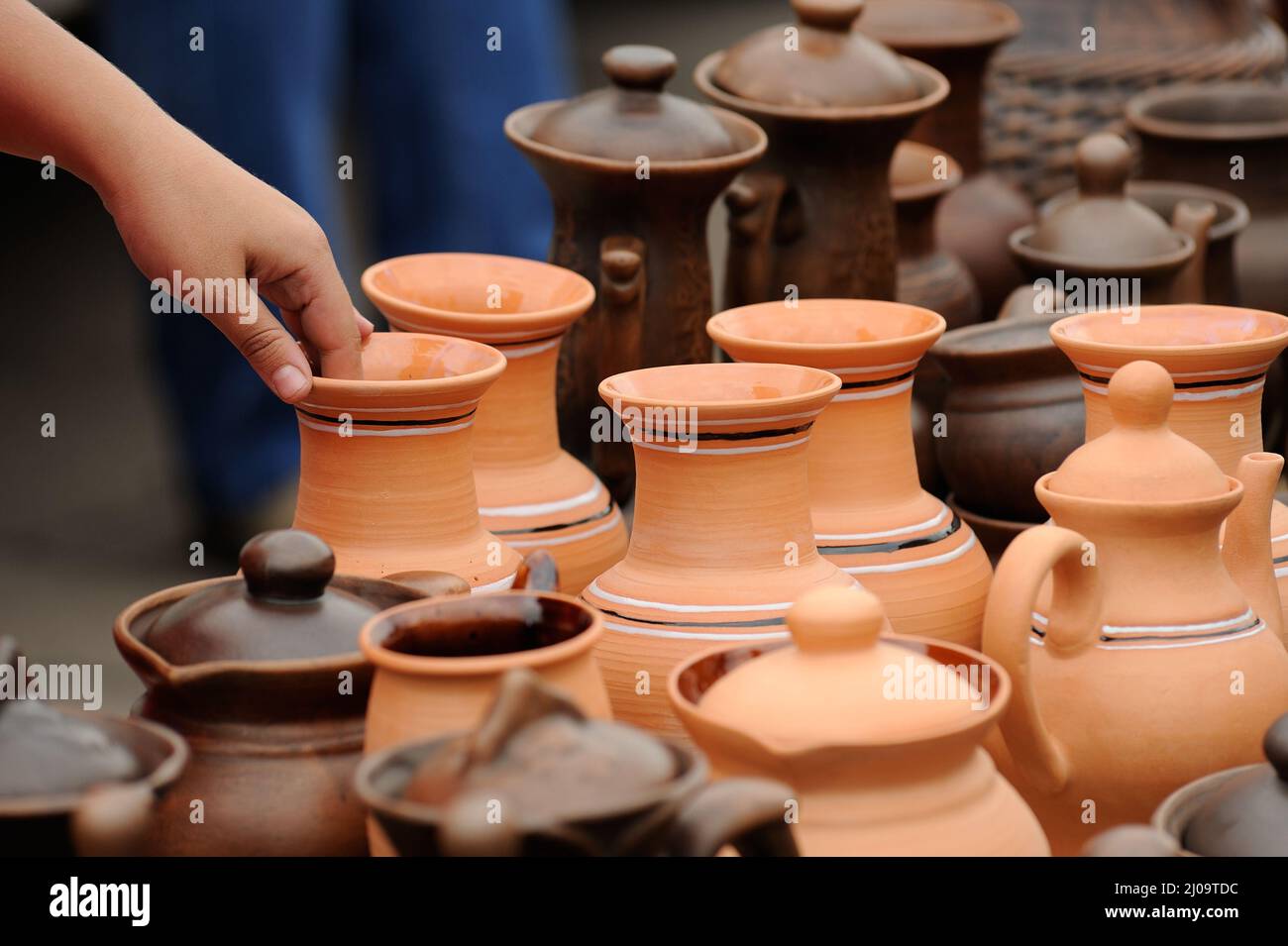 Row of new handmade pottery with woman's hand horizontal Stock Photo ...