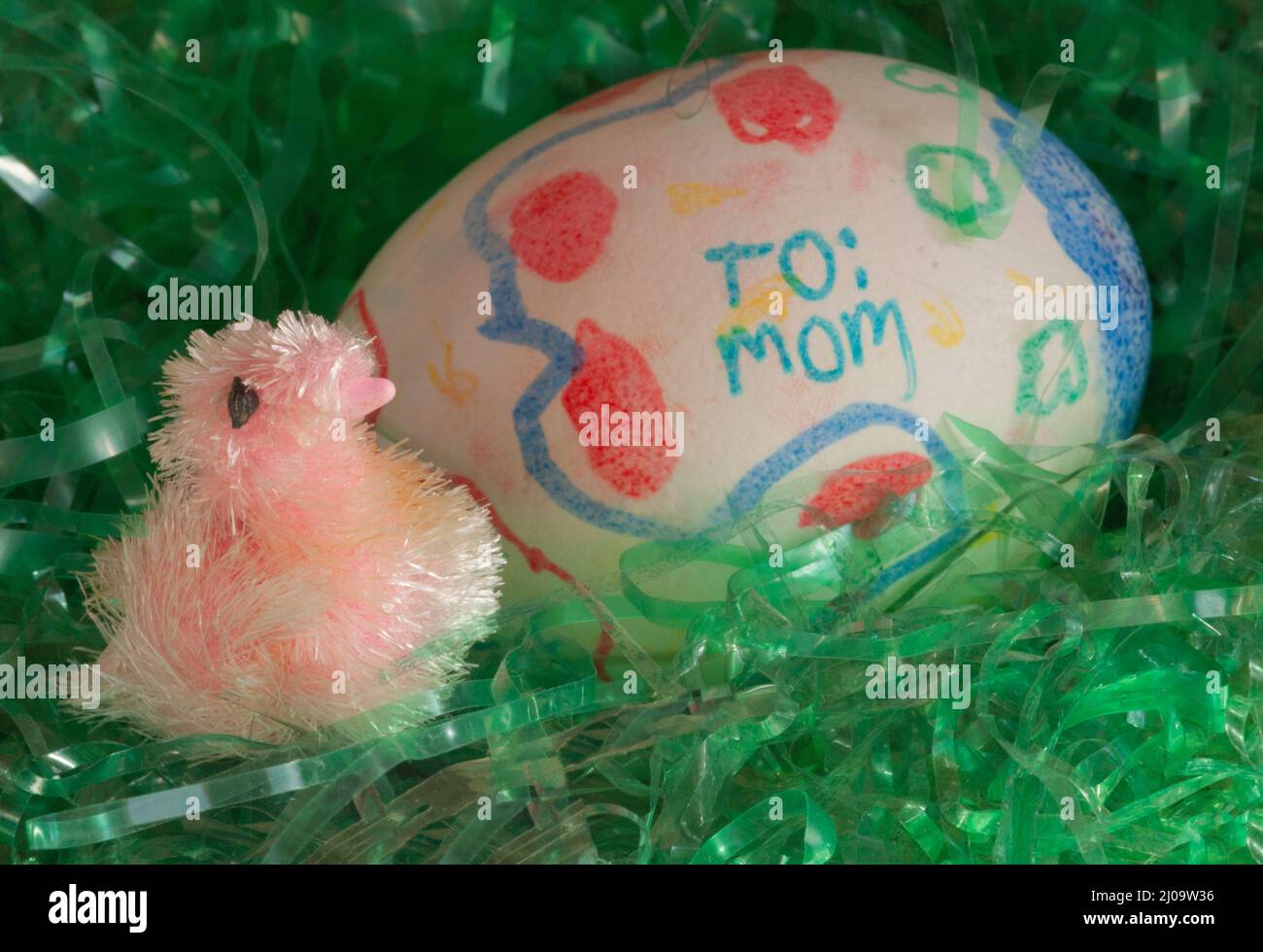 "To Mom" hand written by a child on a DIY kid decorated Easter egg. The ...