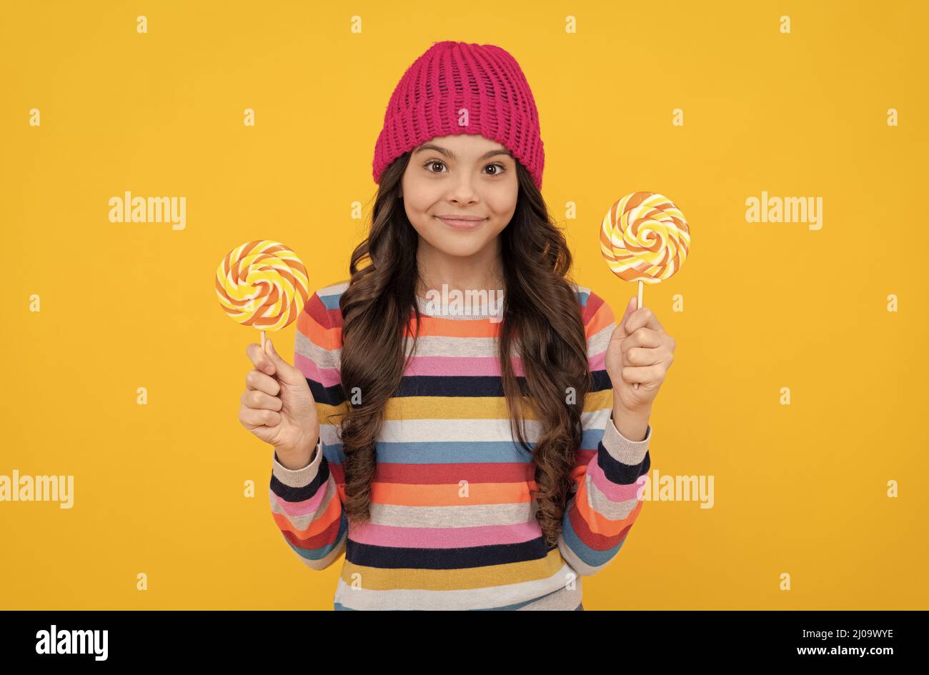 hipster kid with colorful lollypop sugar candy on stick. caramel candy ...