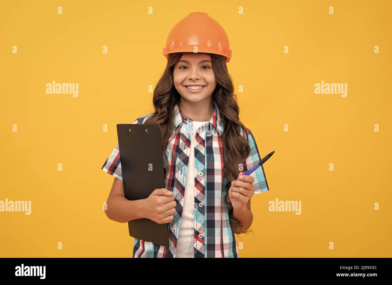 child in helmet hold project. construction documents. signing a ...