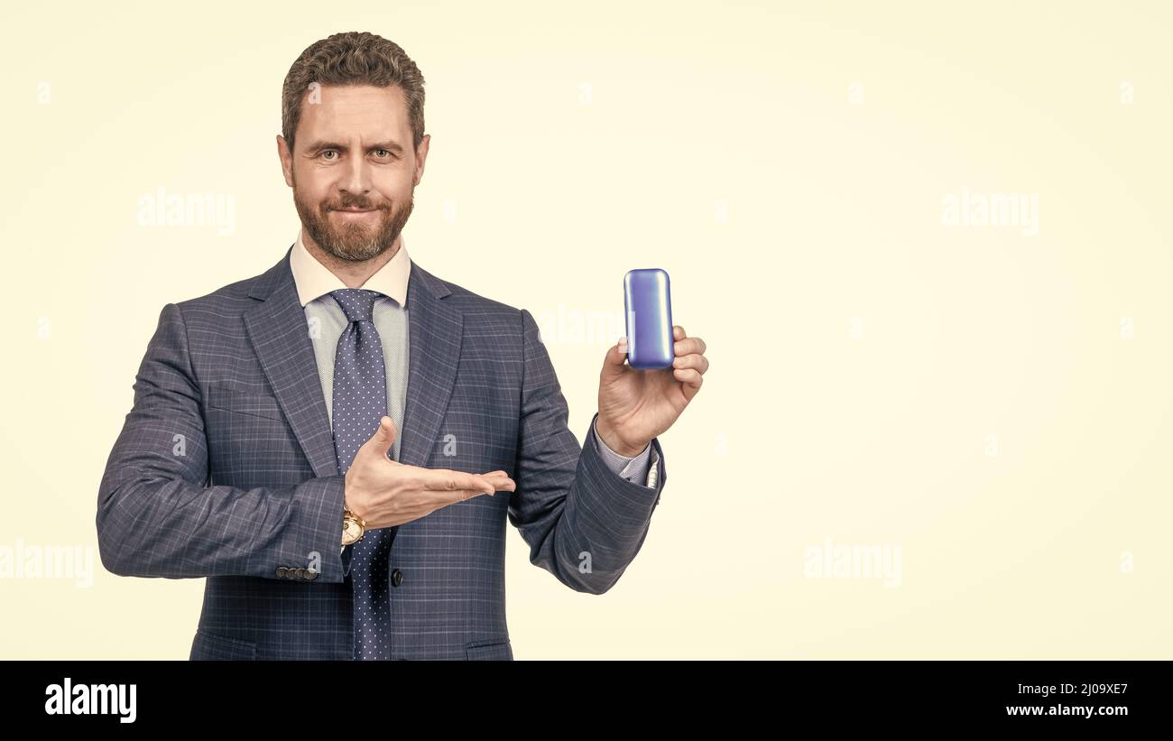 businessman demonstrating modern gadget. successful ceo holding blue ...