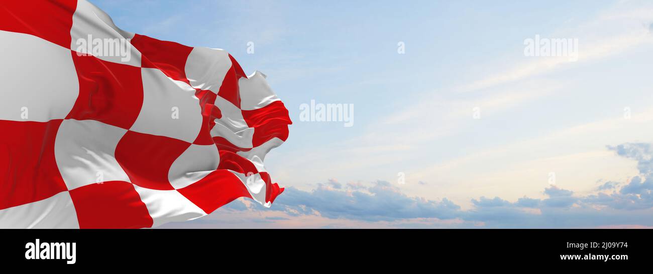 flag of North Brabant , Netherlands at cloudy sky background on sunset ...