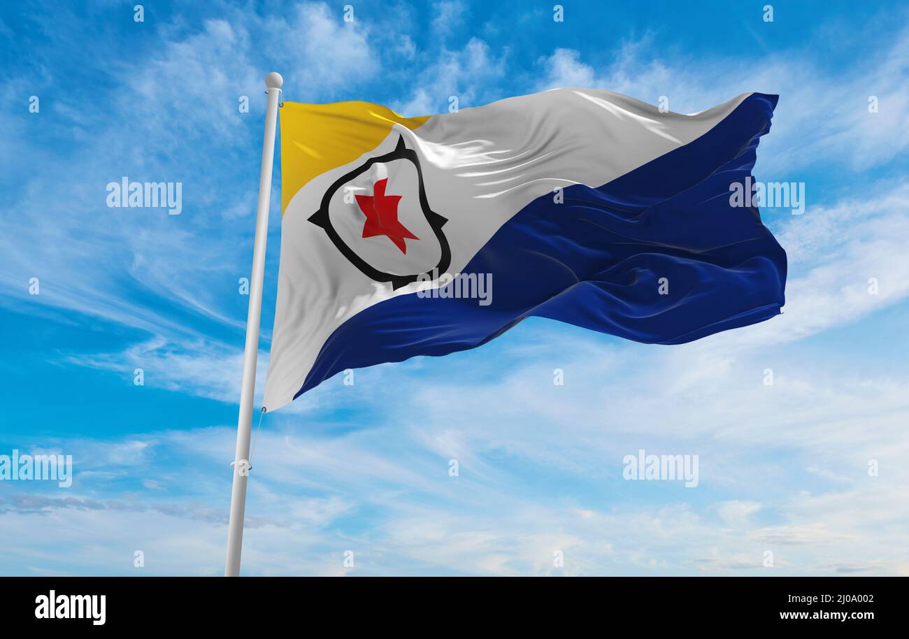 flag of Bonaire , Netherlands at cloudy sky background on sunset ...