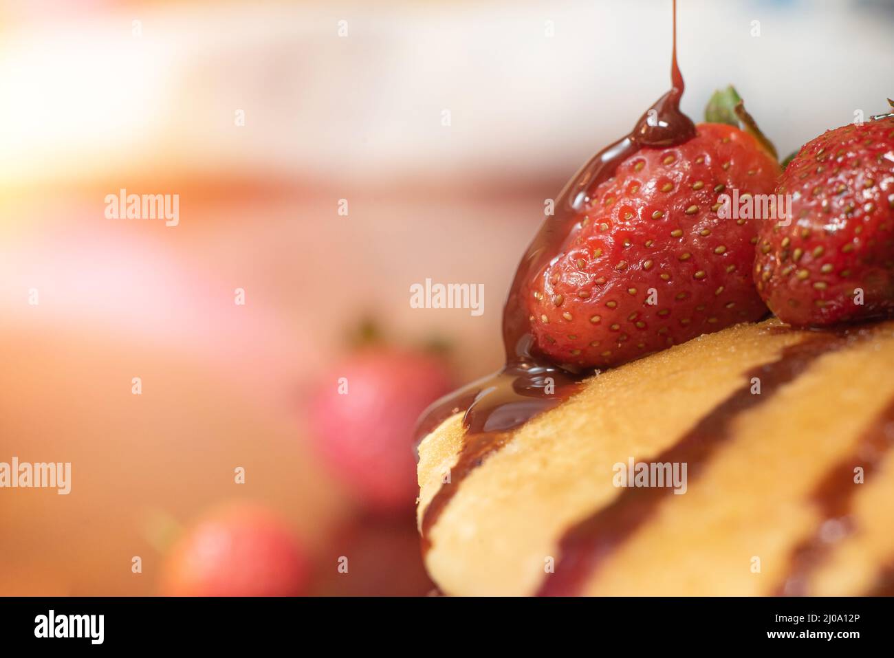 Closeup of a strawberry dripping chocolate syrup Stock Photo - Alamy
