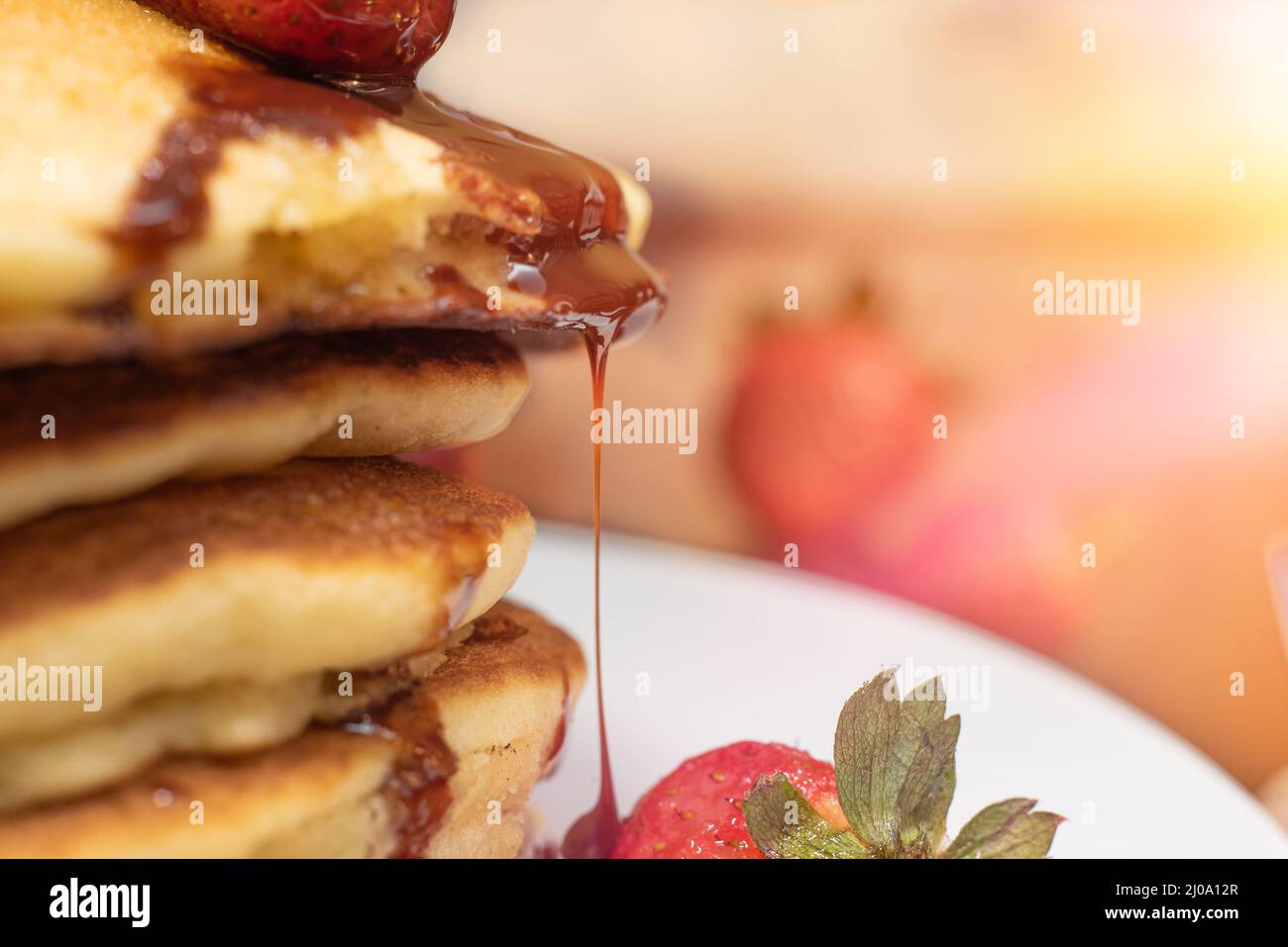 Closeup of a hot cake with strawberries dripping chocolate syrup Stock ...