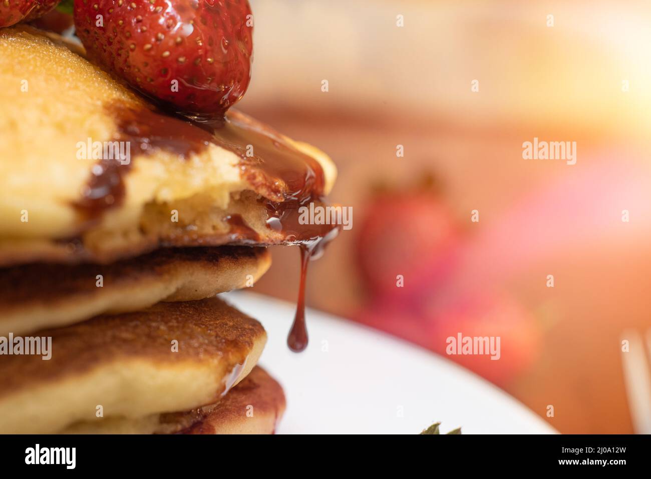 Closeup of a strawberry dripping chocolate syrup Stock Photo - Alamy