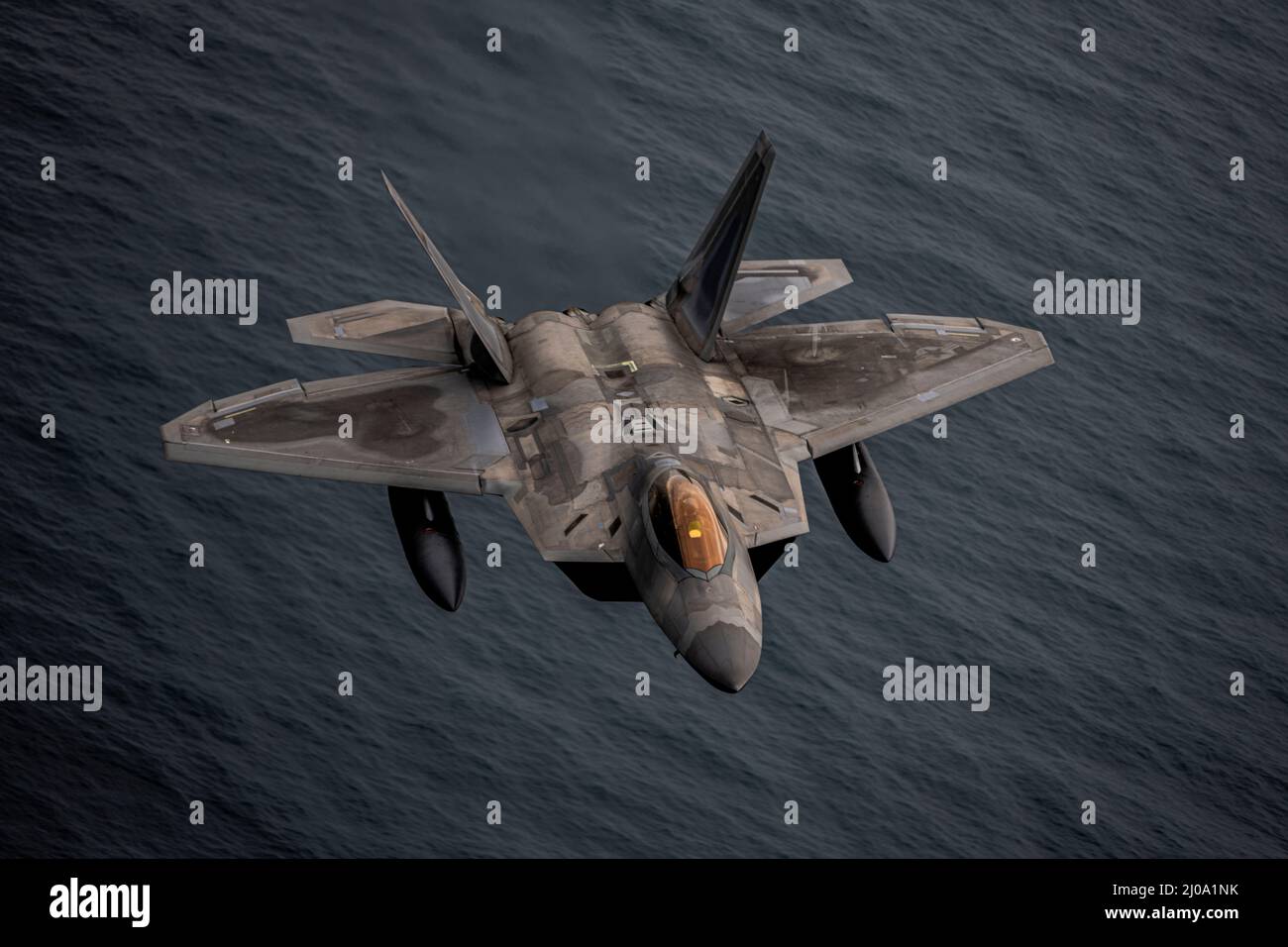 An F-22 Raptor, assigned to Alaska NORAD Region, flies behind a KC-135R ...
