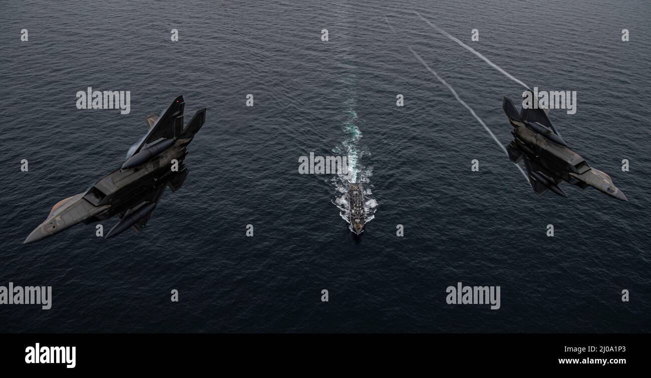 F-22 Raptors, assigned to Alaska NORAD Region, fly over guided missile ...