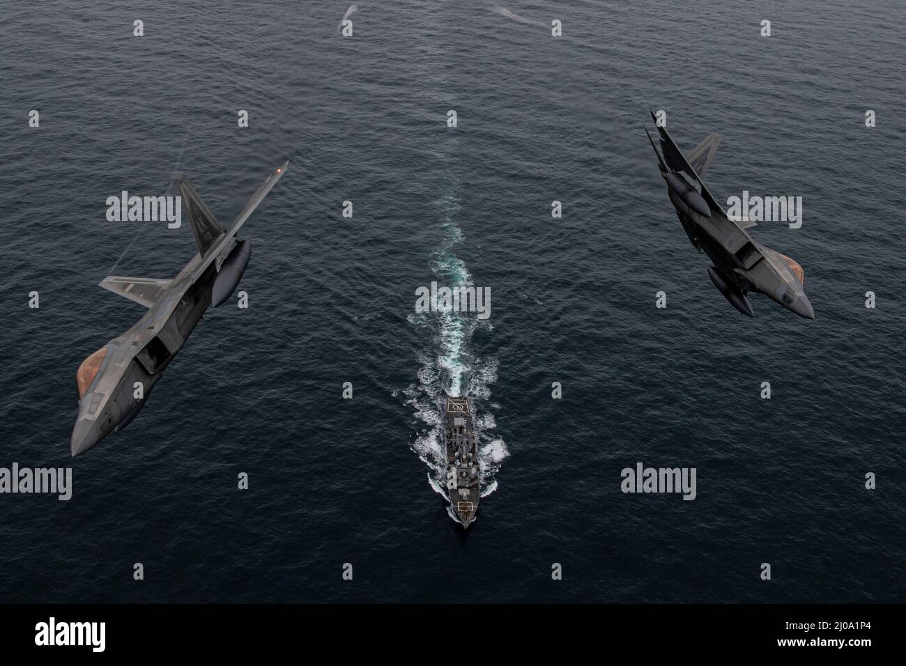 F-22 Raptors, assigned to Alaska NORAD Region, fly over guided missile ...