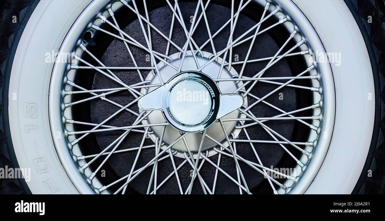 Antique chrome spoke wheel with white-faced rubber and center nut Stock ...
