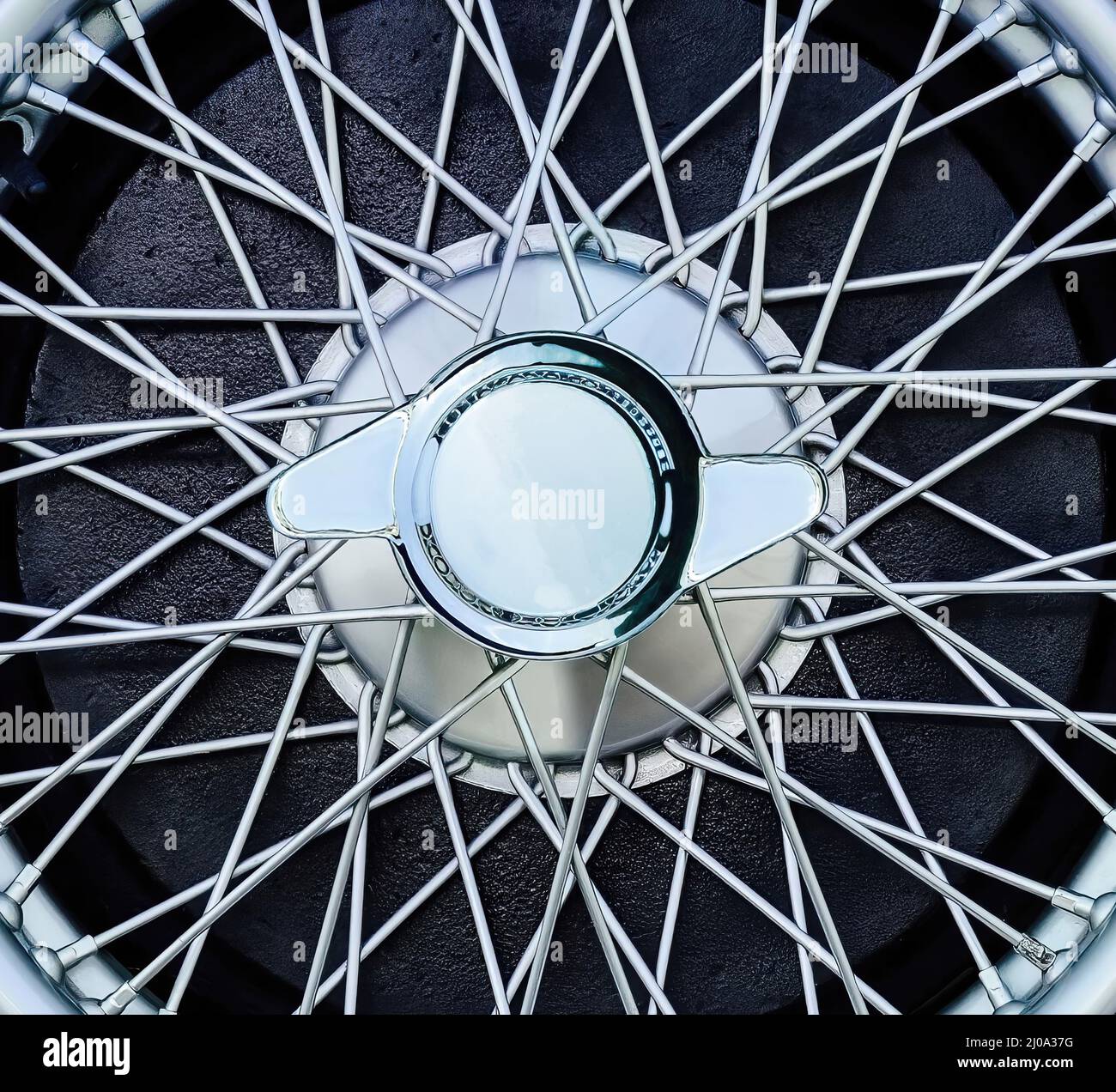 Antique chrome spoke wheel with white-faced rubber and center nut Stock ...