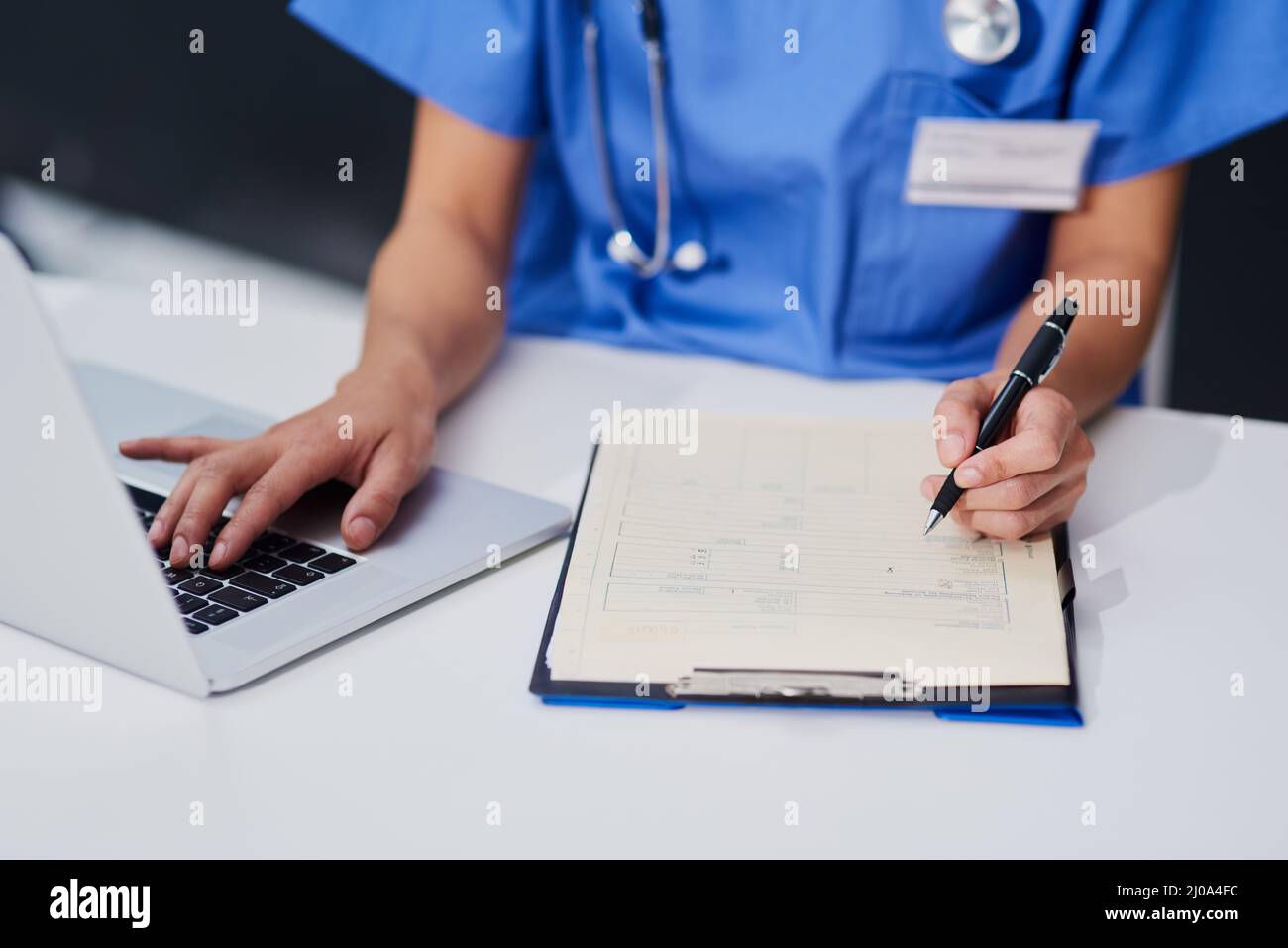Keeping her records up to date. High angle shot of an unrecognizable ...