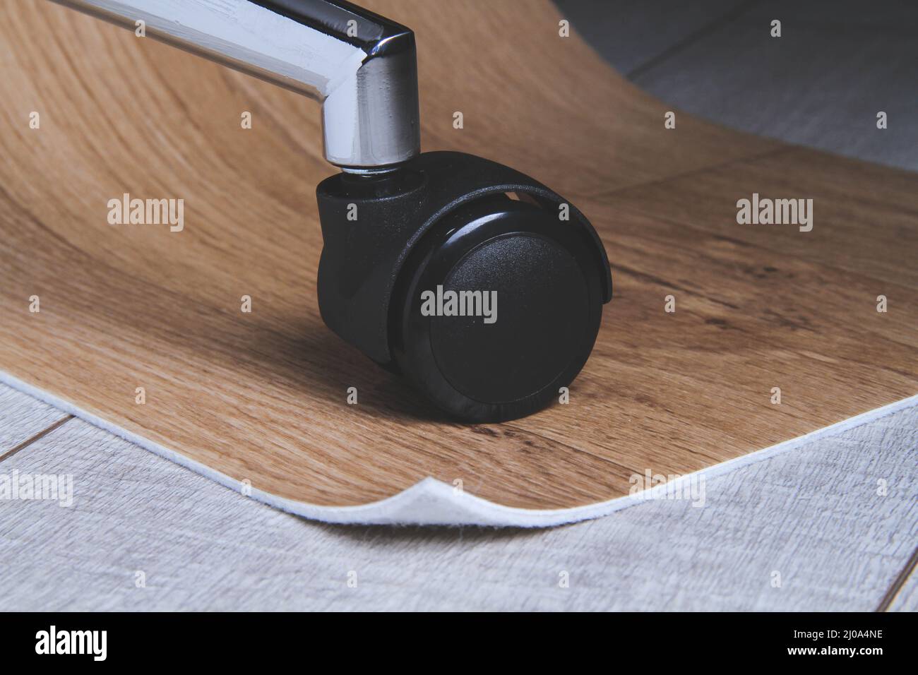 Linoleum in the office. Armchair on wheels on linoleum. Floor ...