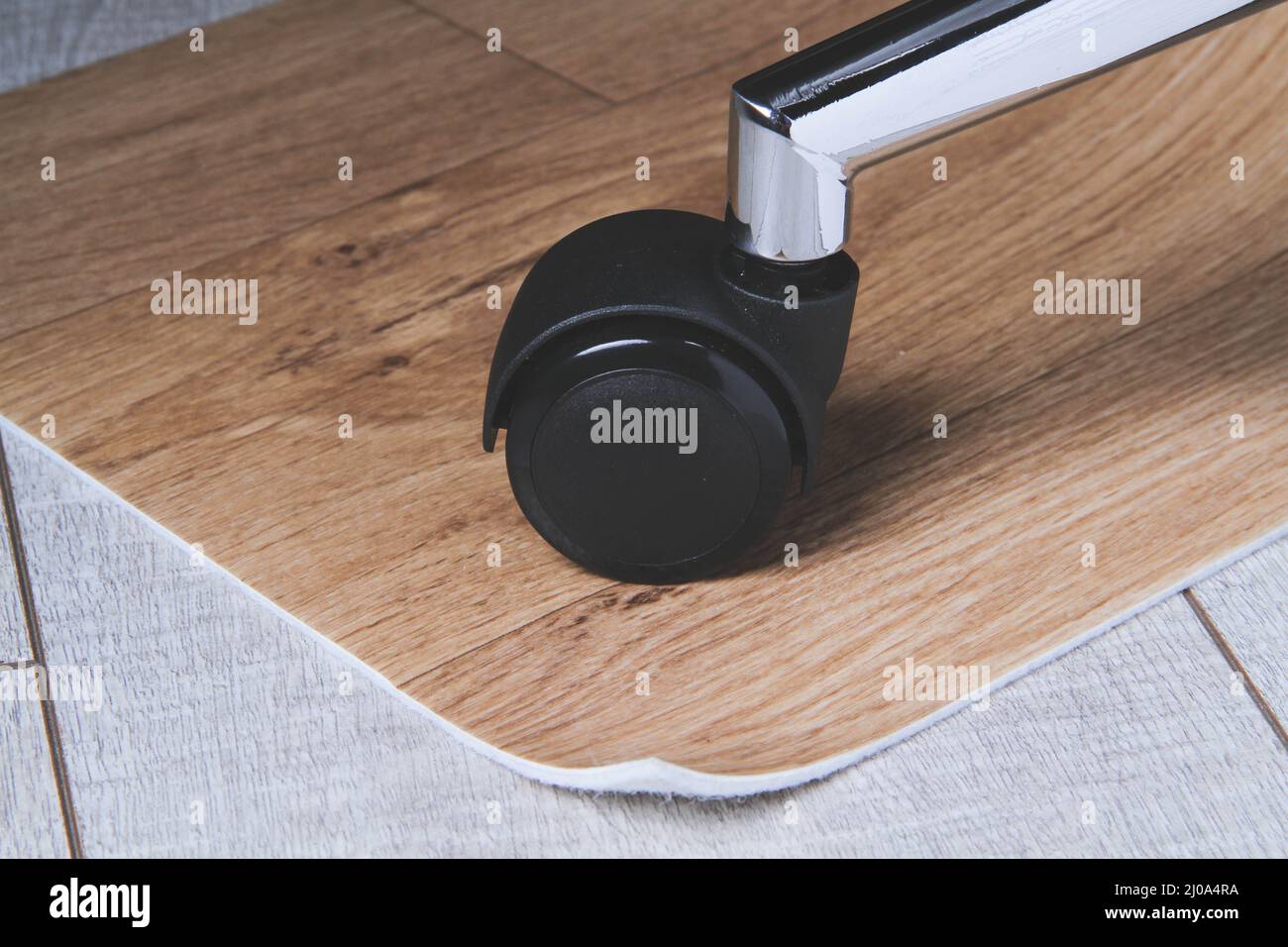 Linoleum in the office. Armchair on wheels on linoleum. Floor ...