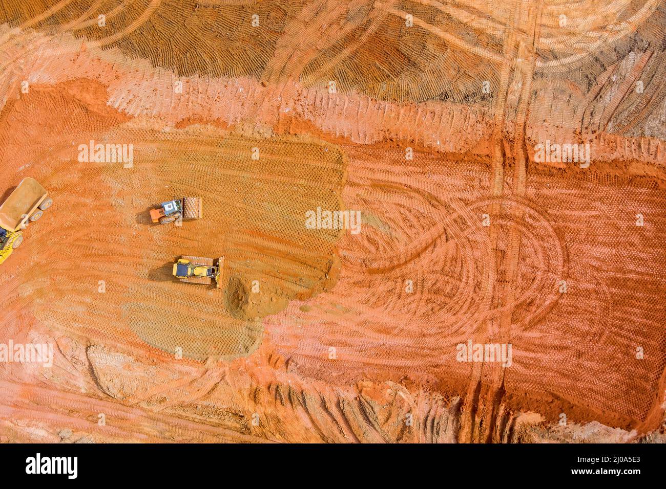Aerial top view of excavator during earthmoving at open pit on ...