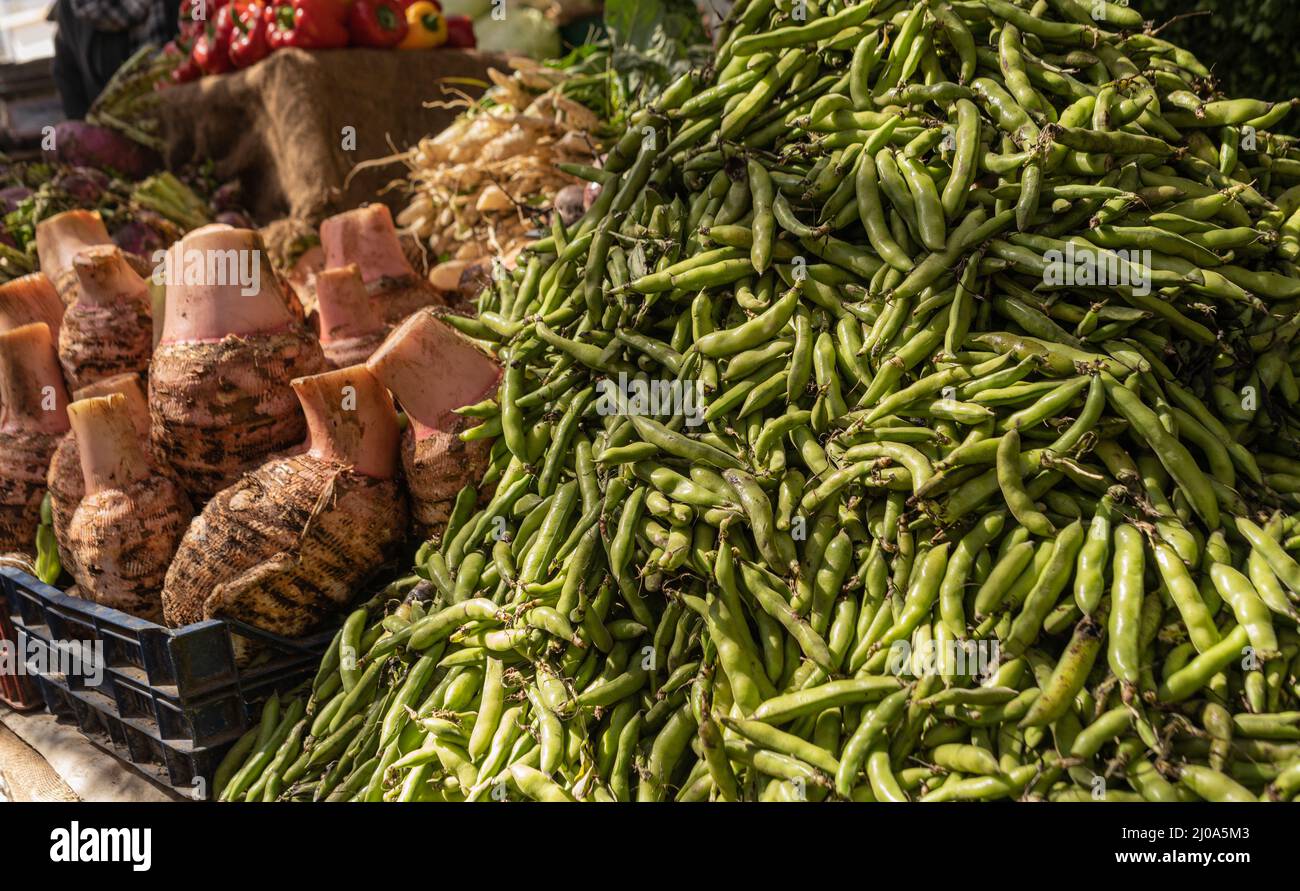 Green fava beans and taro vegetable in local market Stock Photo - Alamy