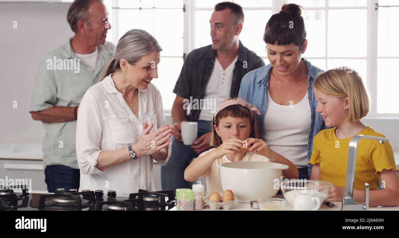 Were going to bake a cake. Shot of a family baking together in the ...