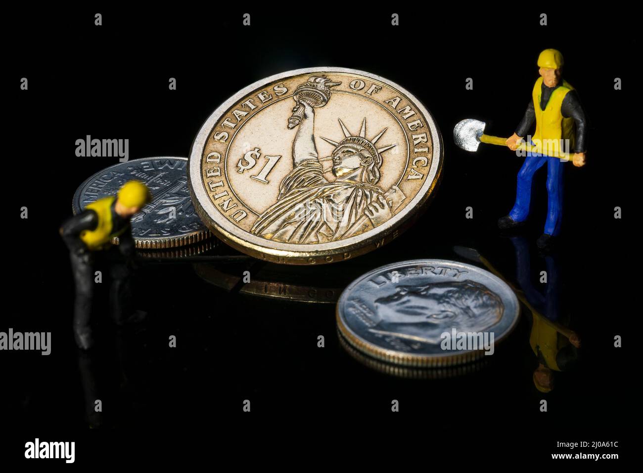 Two workers rescuing a one dollar coin concept of inflation miniature ...