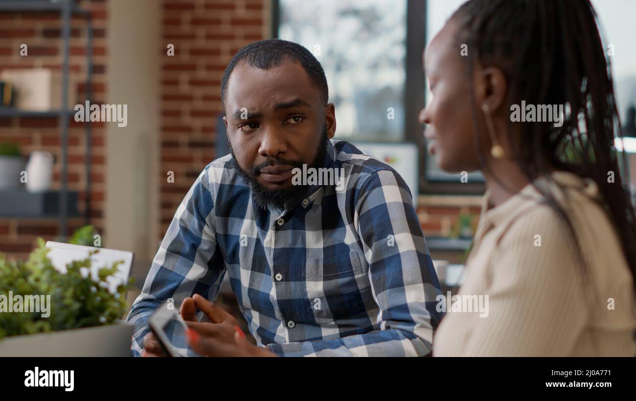 Team of african american people using sales statistics to create ...