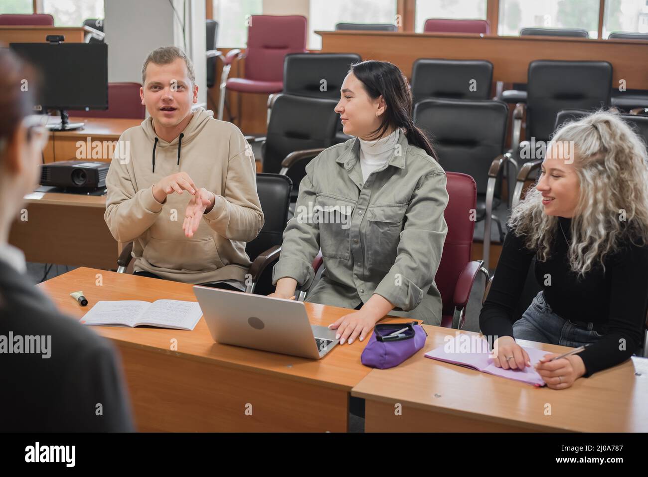 The teacher and students communicate in sign language in the classroom ...