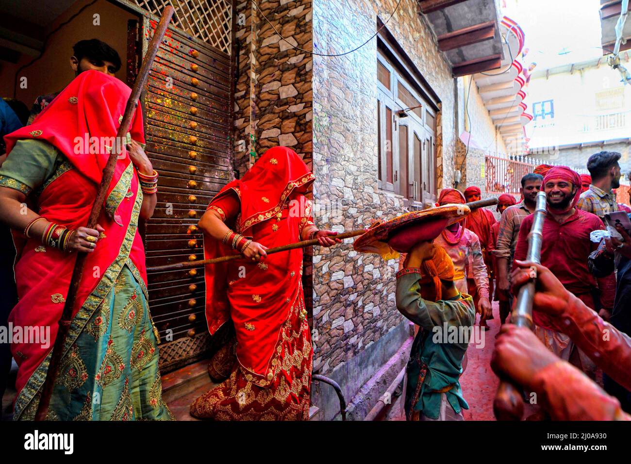 Women holding sticks (Lathi) ritually beat Hindu men during the Lathmar ...