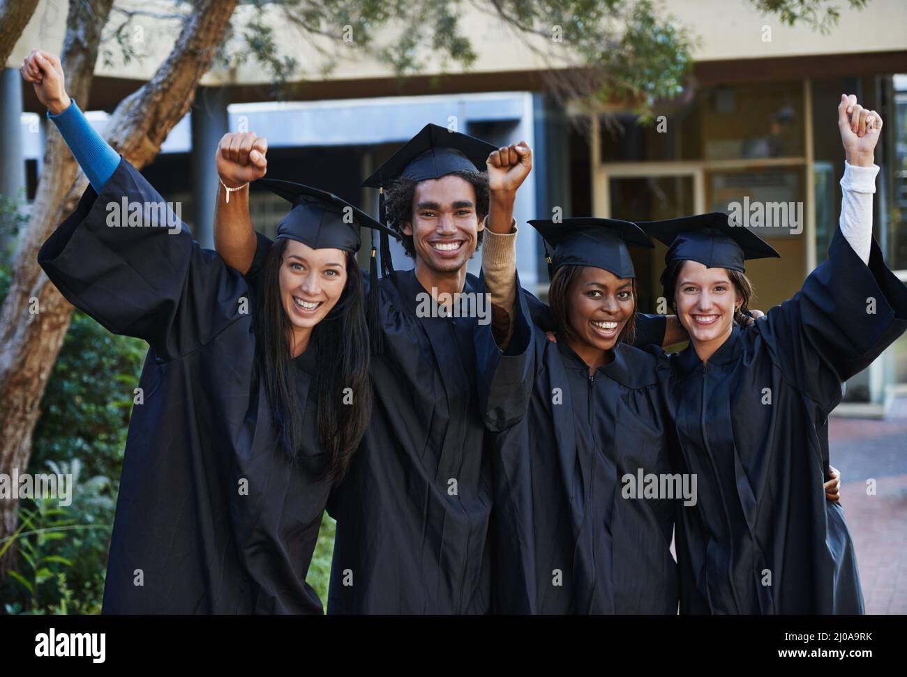 Nothing can stop us now. A group of smiling college graduates ...