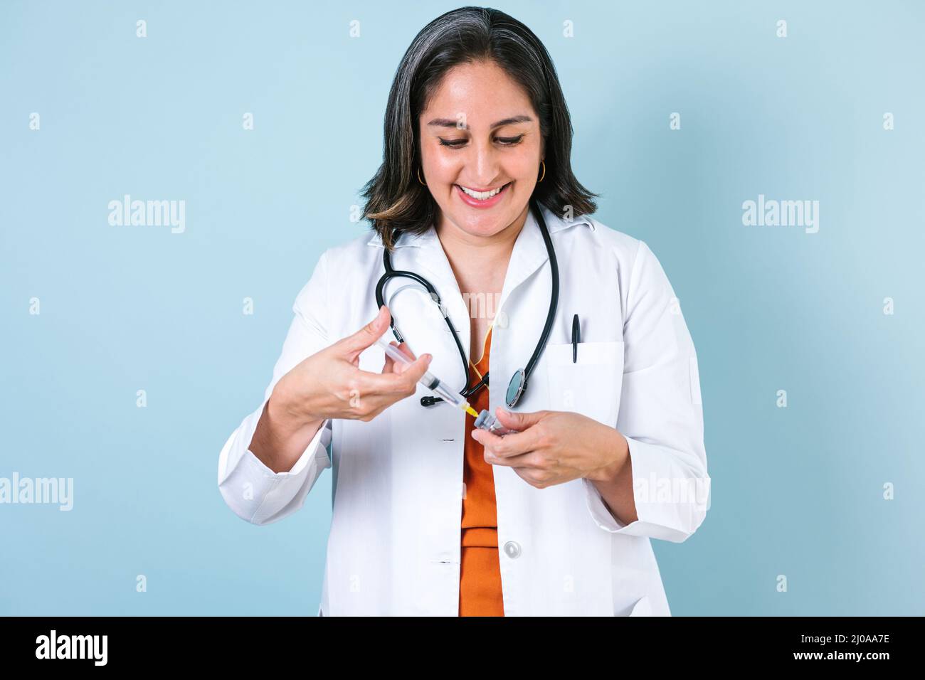 hispanic woman doctor holding vaccine injection in Mexico latin America ...