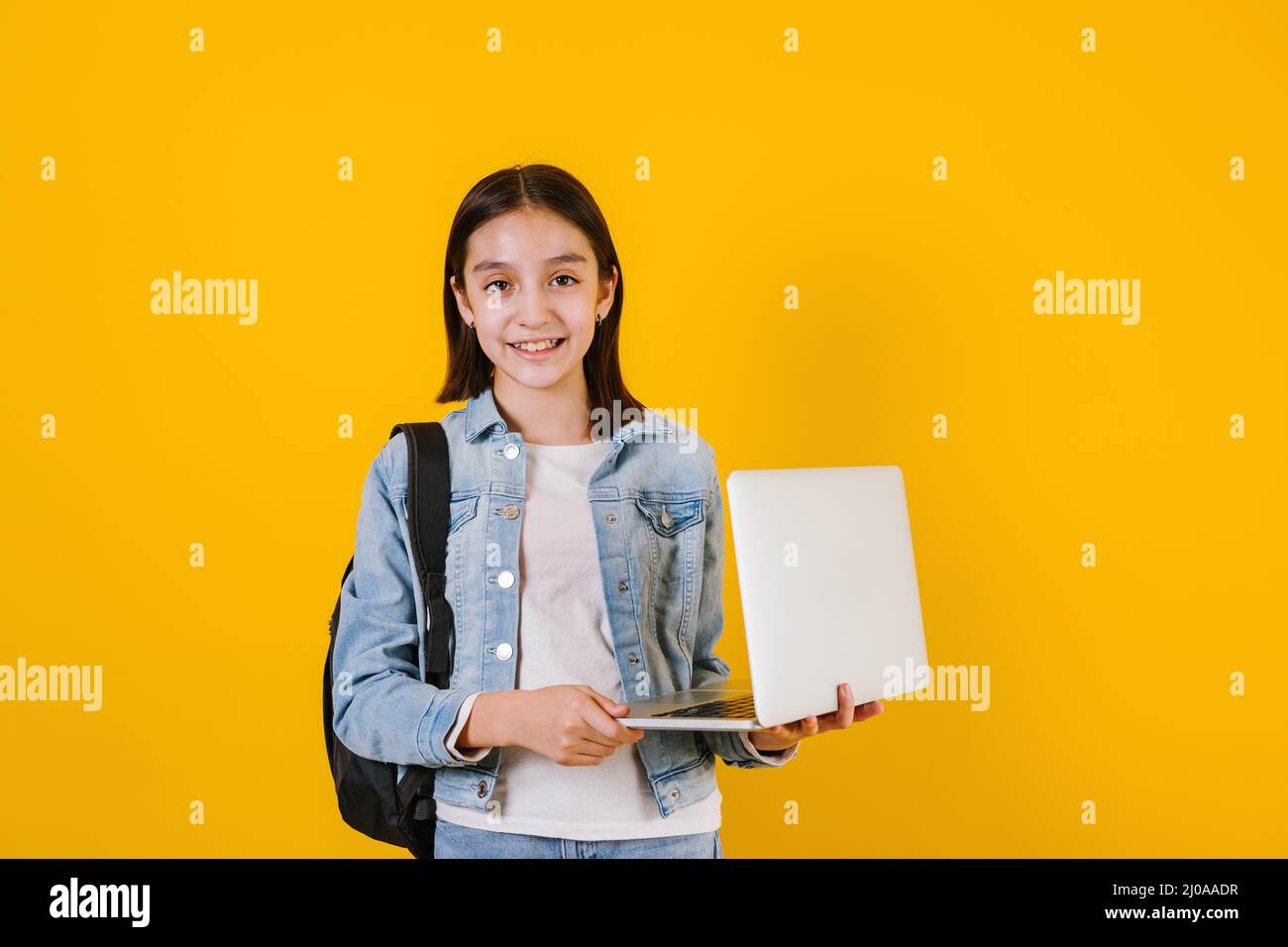 portrait of young hispanic child teen girl student with computer lap ...