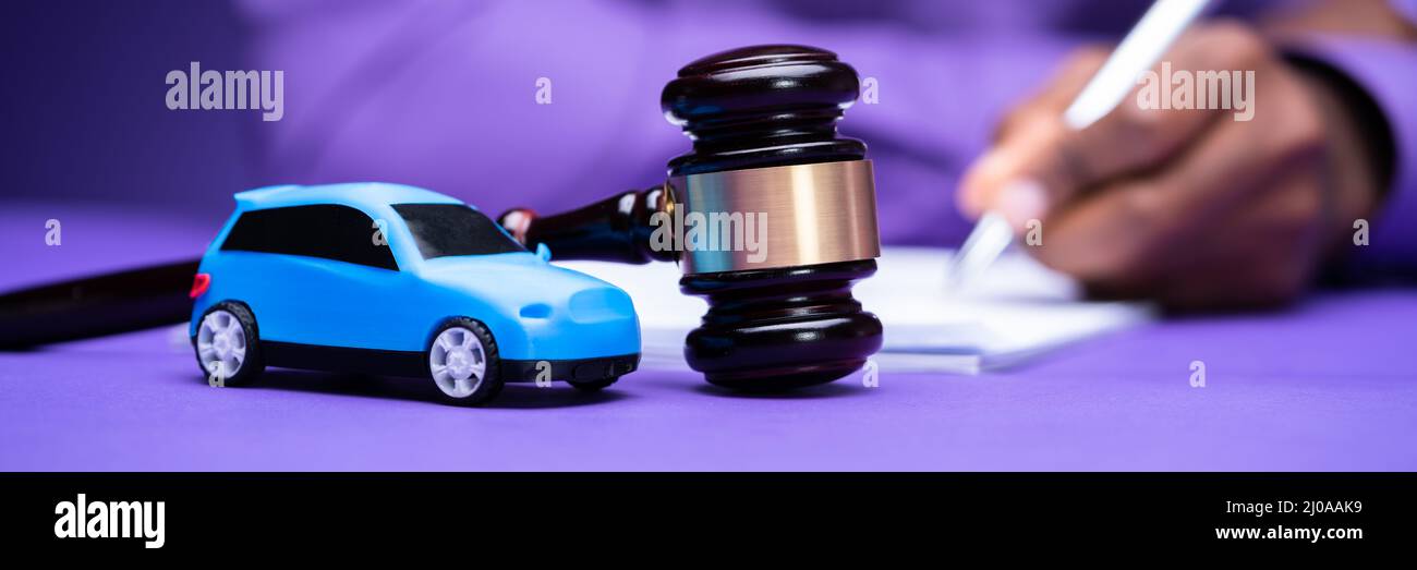 Small Blue Car In Front Of Judge Mallet Stock Photo - Alamy
