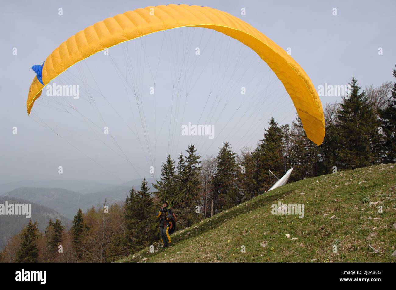 Paraglider pilot at take off Stock Photo - Alamy