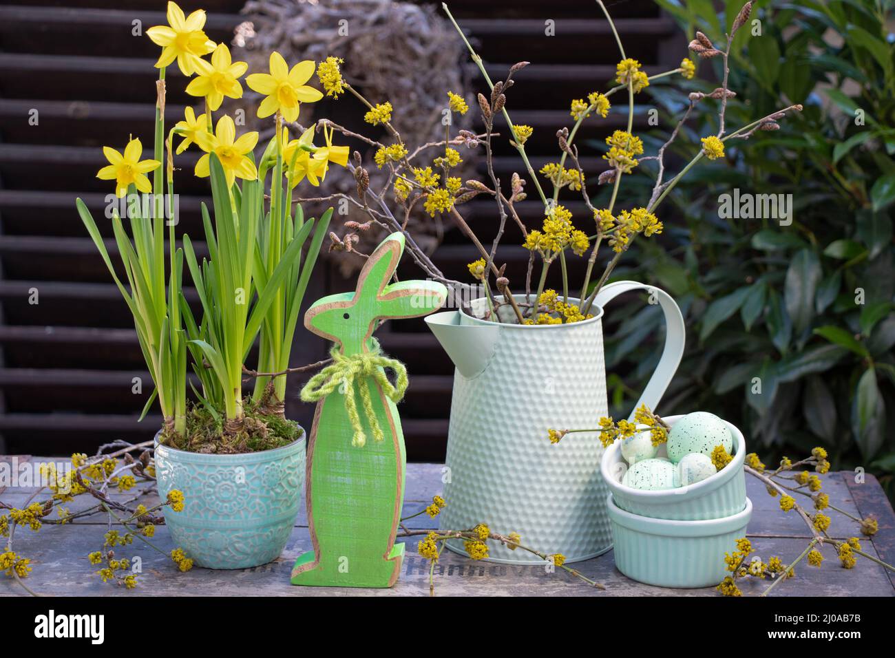 easter decoration with easter bunny, narcissus and bouquet of cornelian ...