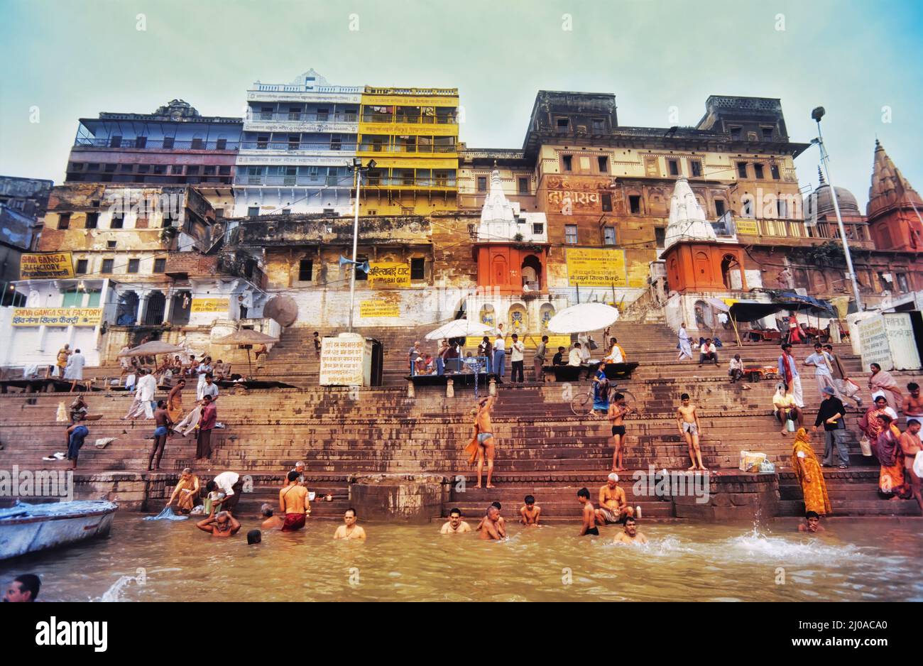 Hindu devotees ritually bathing on the ghats of the Ganges River ...