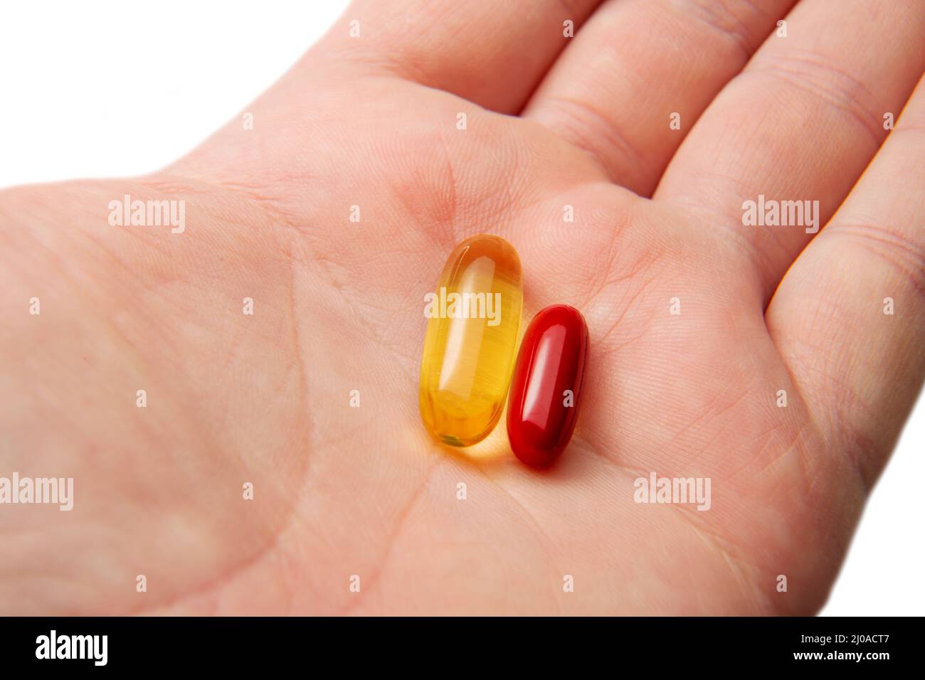 Two medicines capsules tablets are in the man's hand. The concept of ...