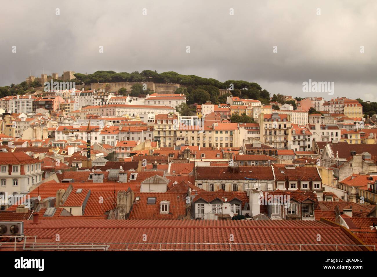 Cityscape of Lisbon with buildings with red roofs on an overcast day ...