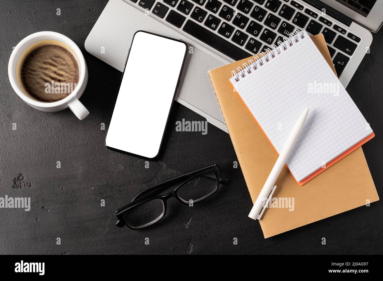 Notepad is on top of office desk table with laptop and supplies Stock ...