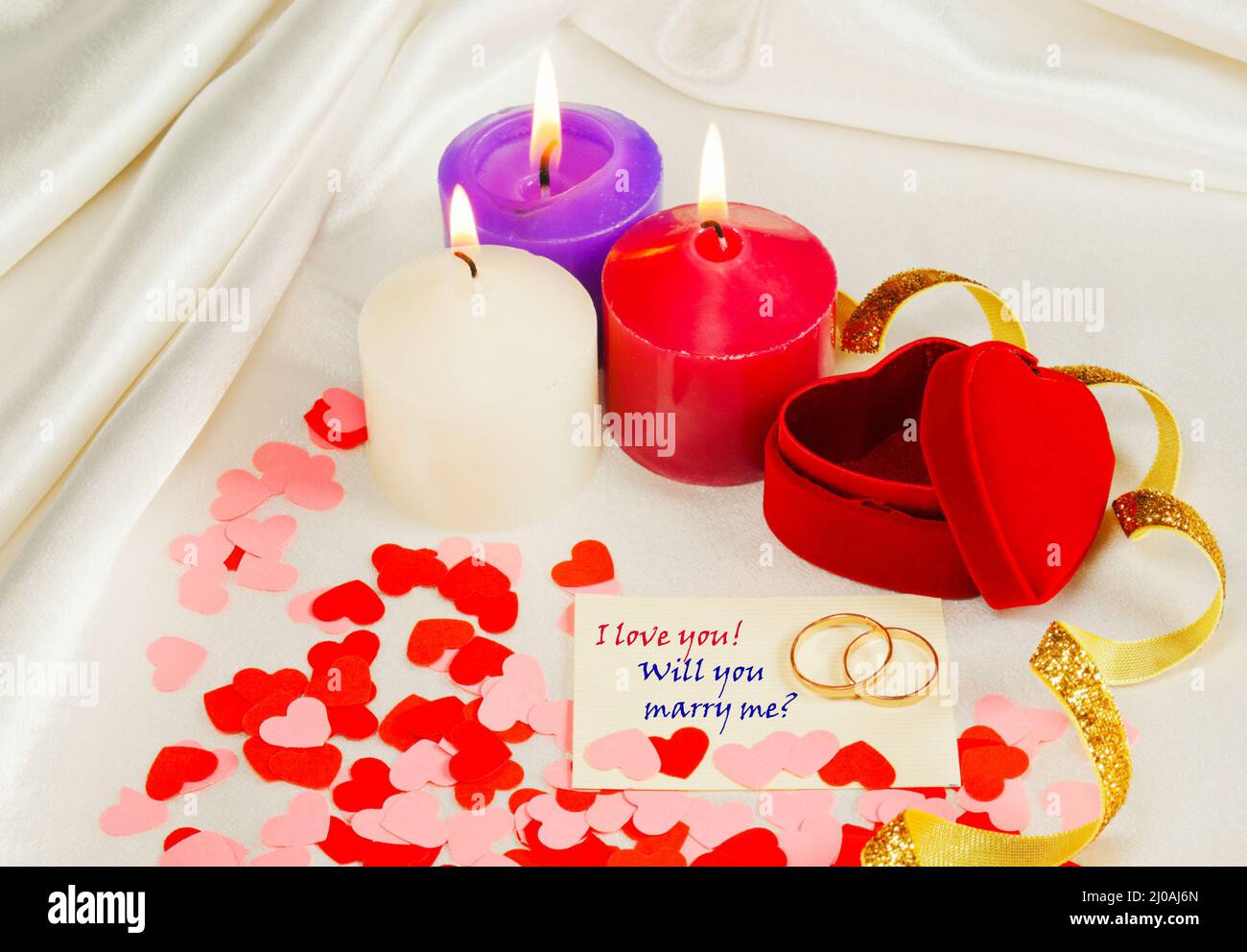 Two rings and a card with marriage proposal Stock Photo - Alamy