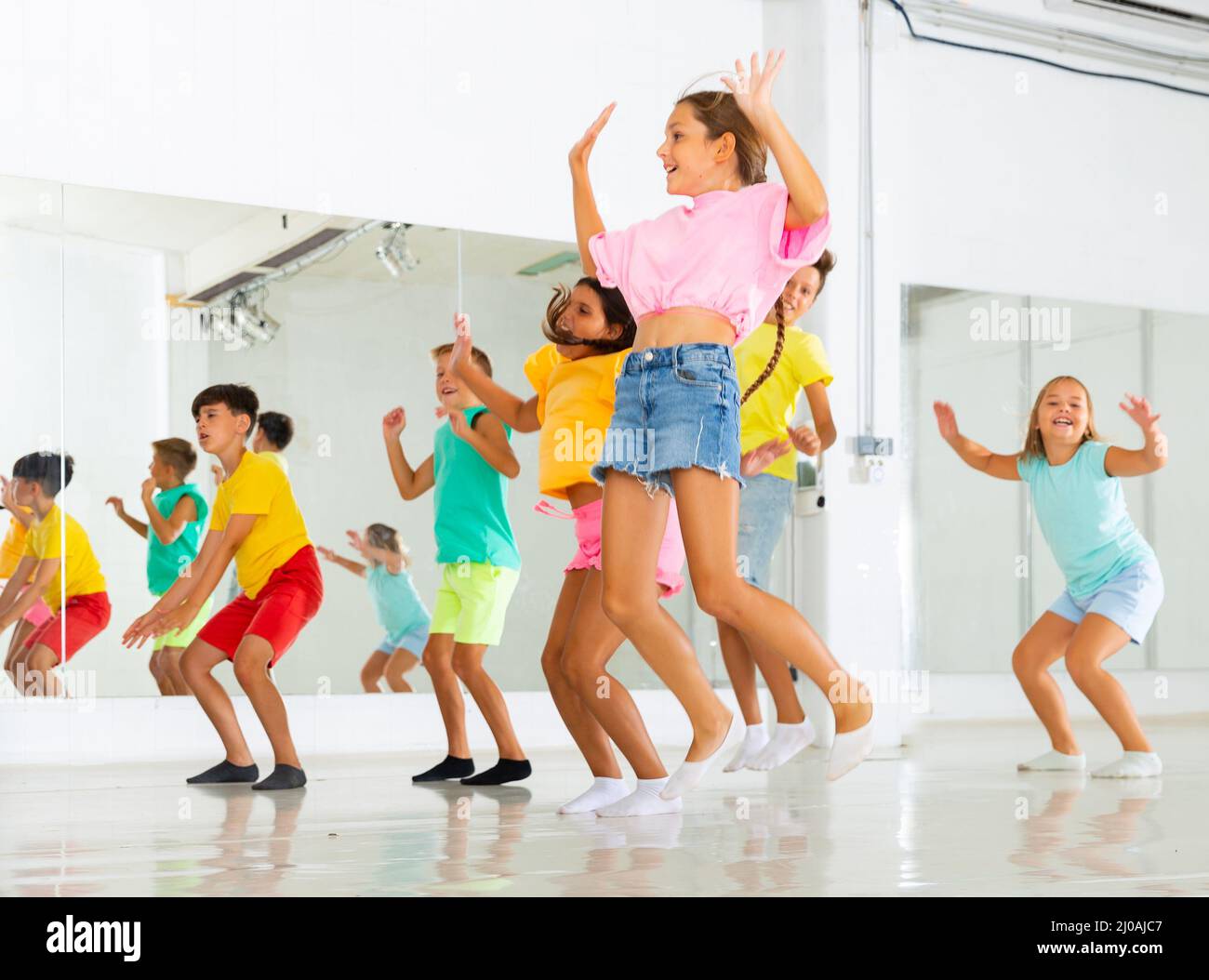 Happy sporty kids jumping in modern dance studio Stock Photo - Alamy