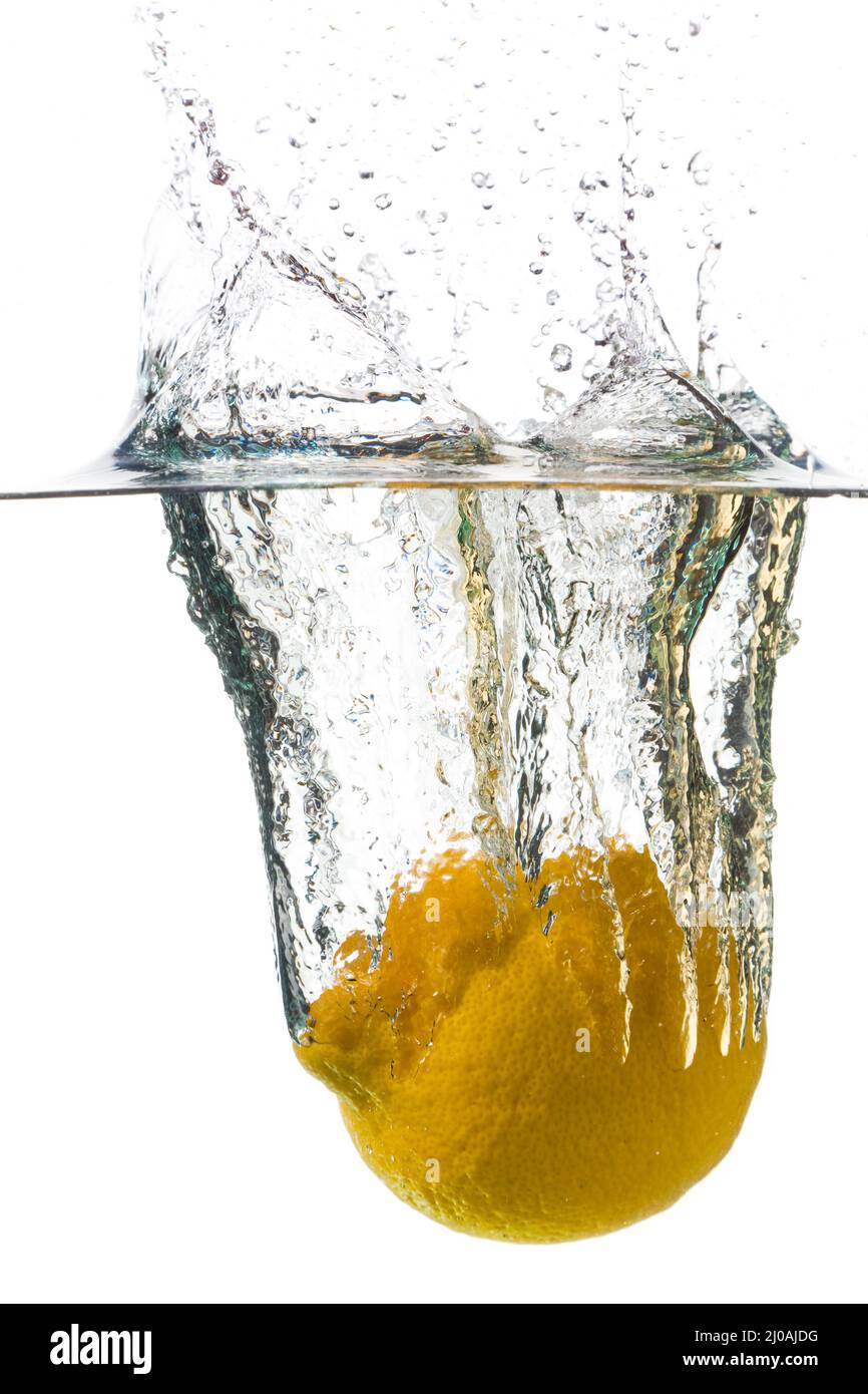 Lemon falling in a water Stock Photo - Alamy