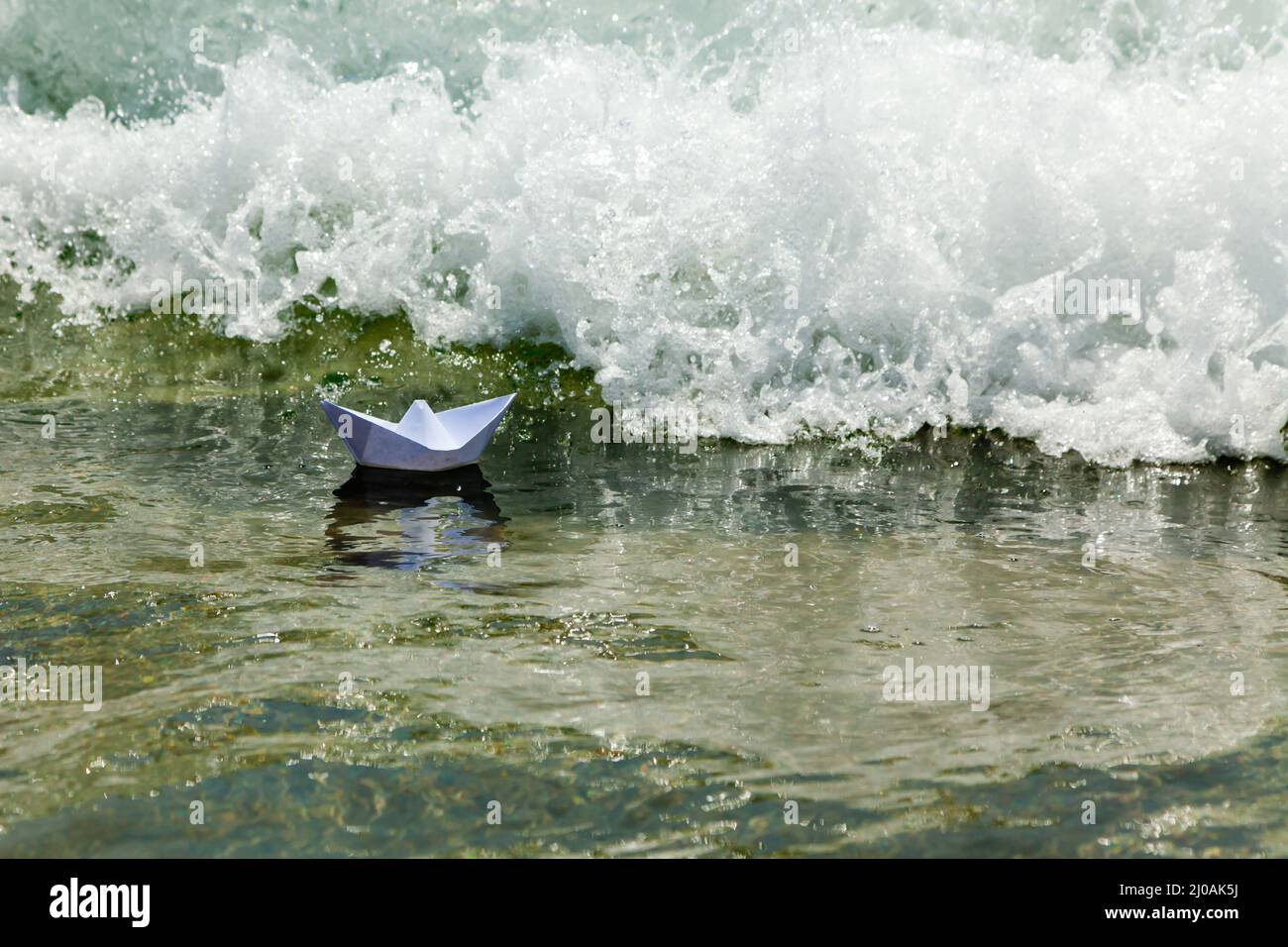 Paper boat now die in a huge wave Stock Photo - Alamy