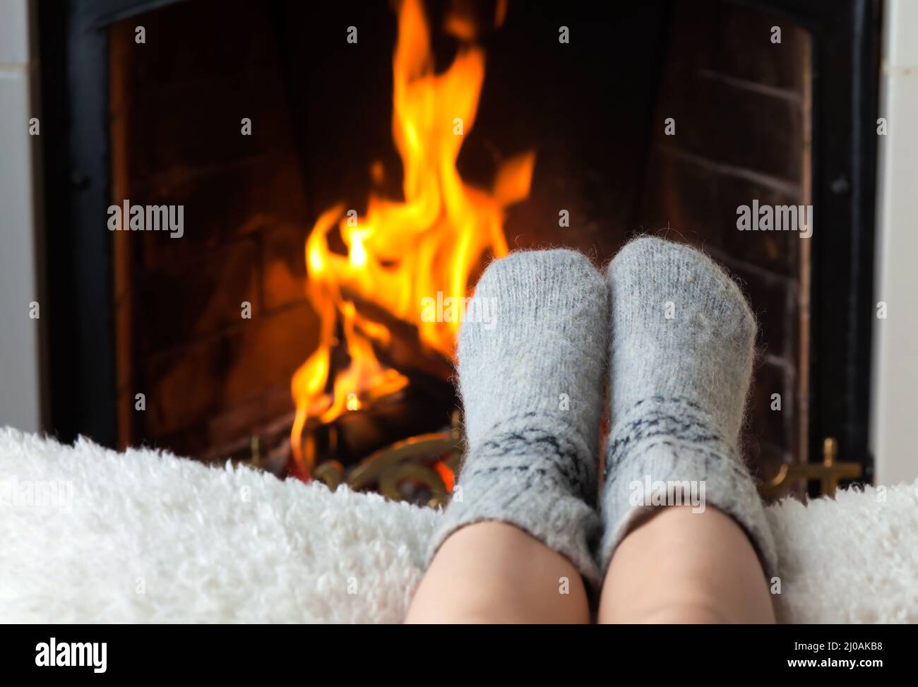 Children's feet are heated in the fireplace Stock Photo - Alamy