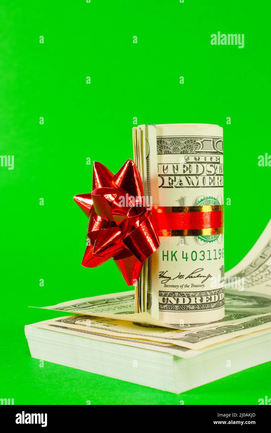 Roll of US dollars tied up with ribbon Stock Photo - Alamy
