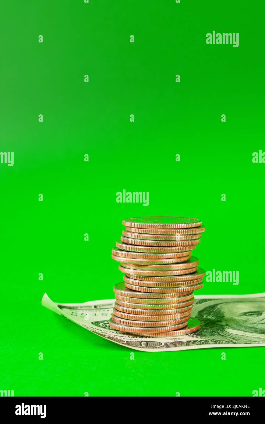 Coins stacked in bars laying on 100 dollar bill Stock Photo - Alamy
