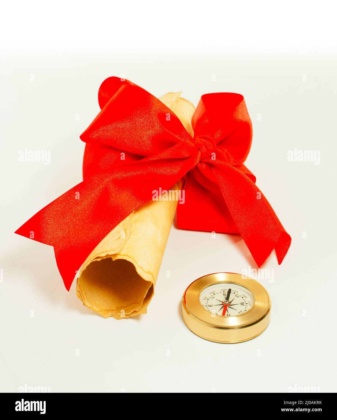 Ancient scroll tied up by red ribbon and compass Stock Photo - Alamy