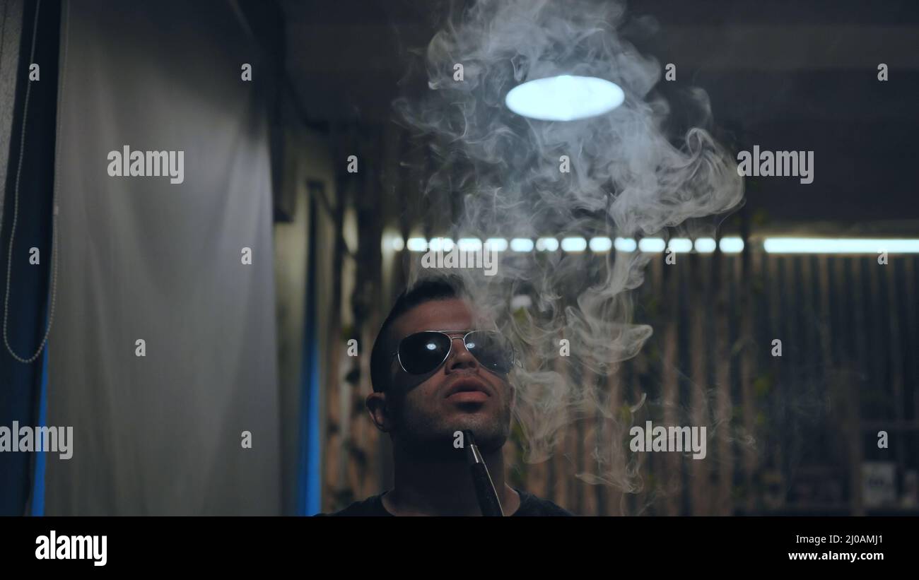 Arabic jordanian young man smokes a hookah Stock Photo - Alamy