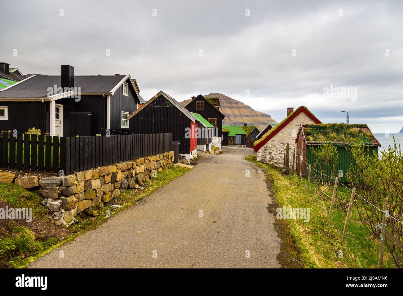 Small village Elduvik situated on the slope of the mountain on Eysturoy ...