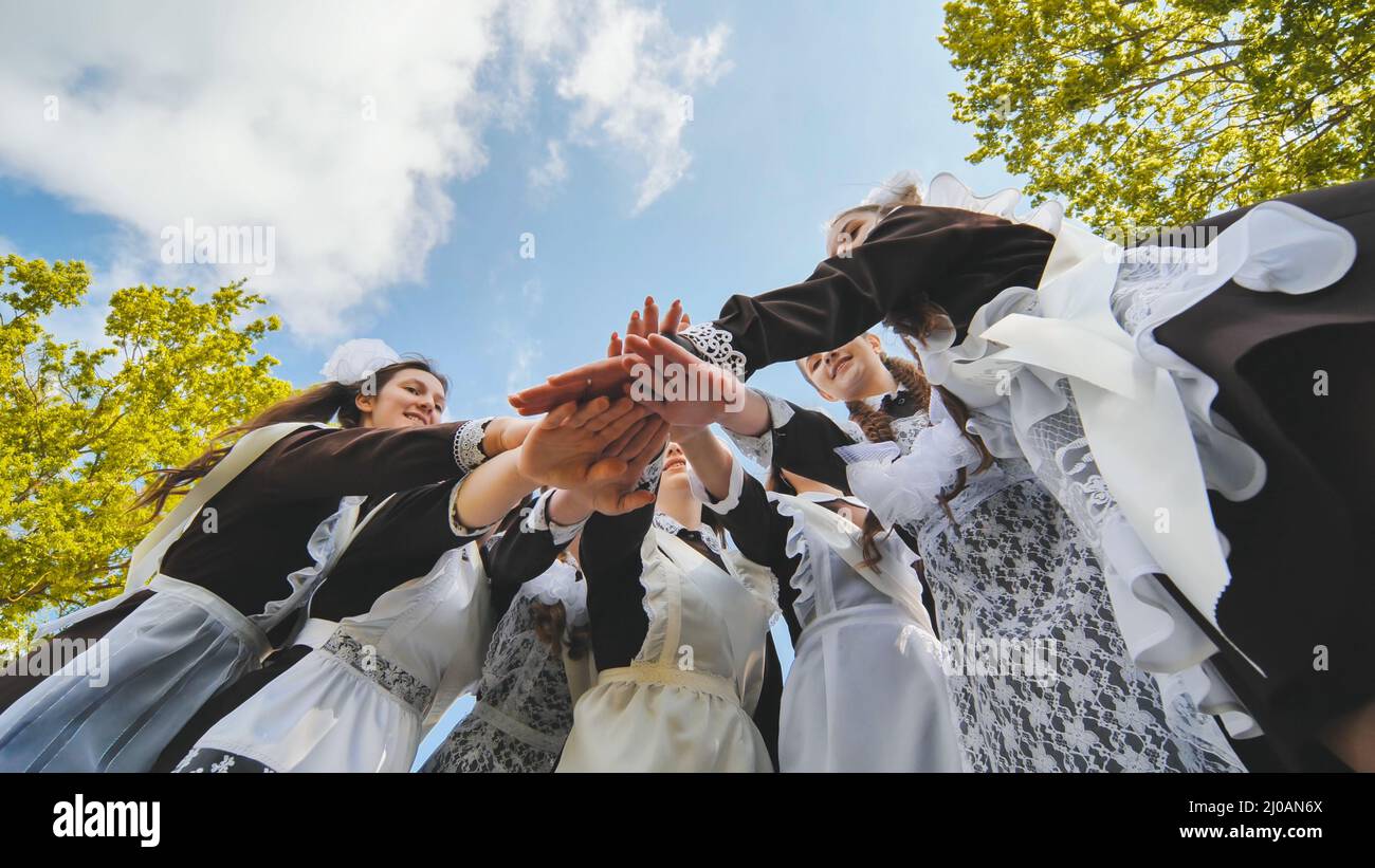 Happy Russian graduates join their hands on the last day of the school ...