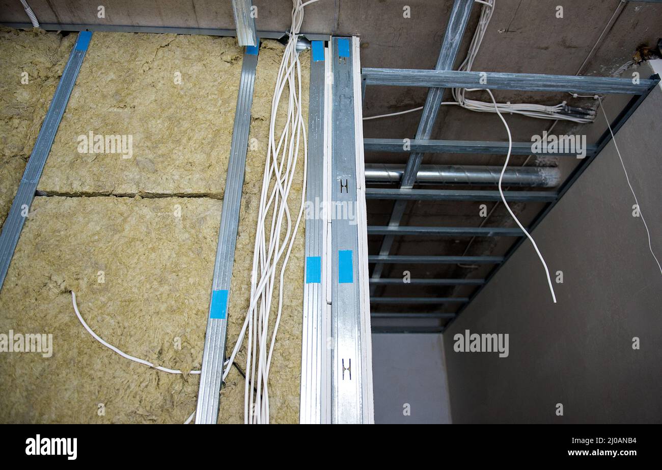 Closeup shot of metal parring and electrical wires on the wall of a ...