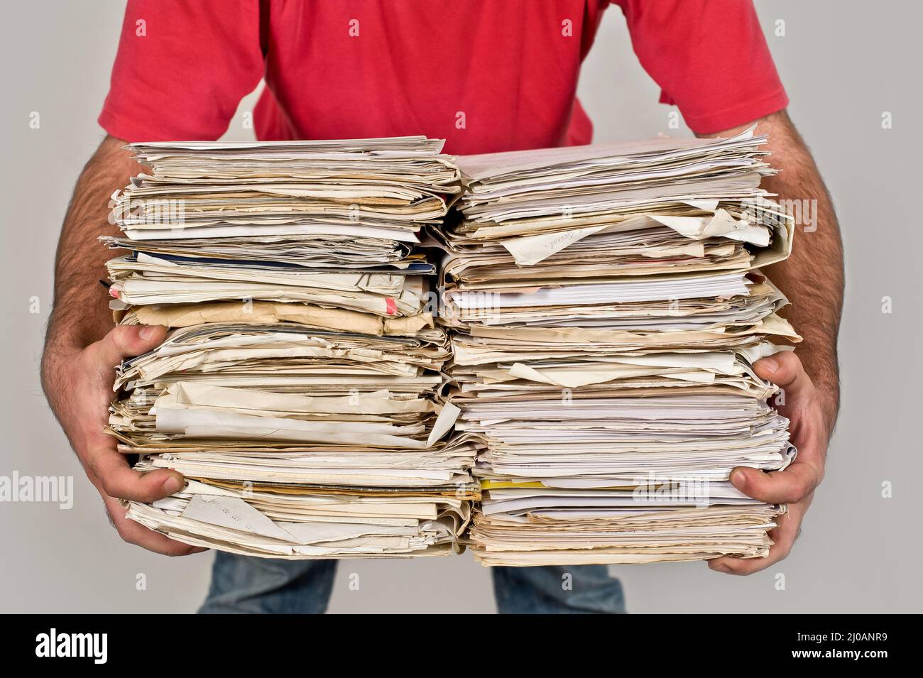 Man hold a pile of old newspapers in the hands Stock Photo - Alamy