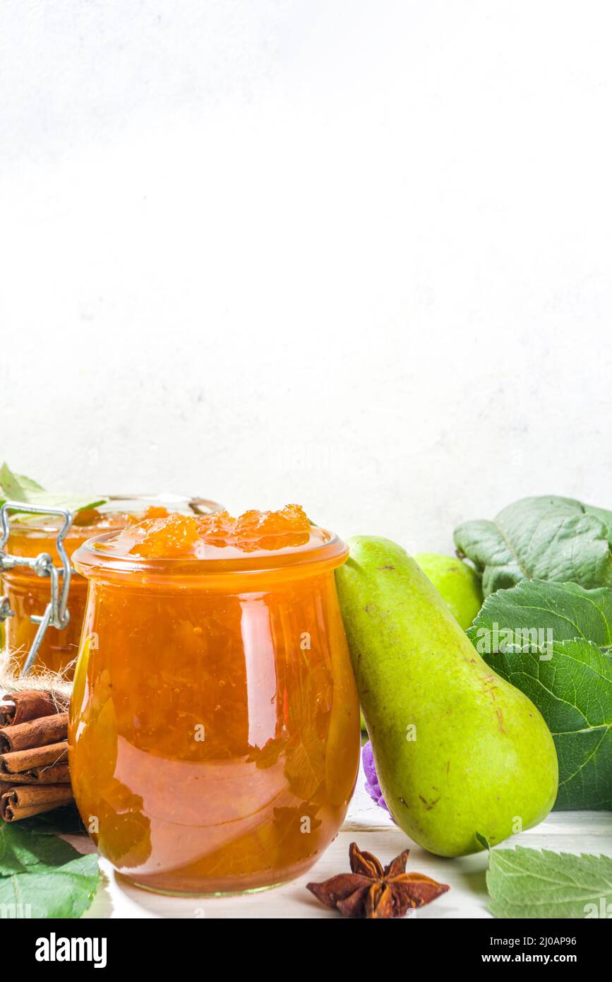 Homemade golden colored pear jam, with farm pears and leaves on white ...